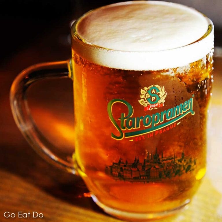 A pint glass of Czech Staropramen beer | Go Eat Do