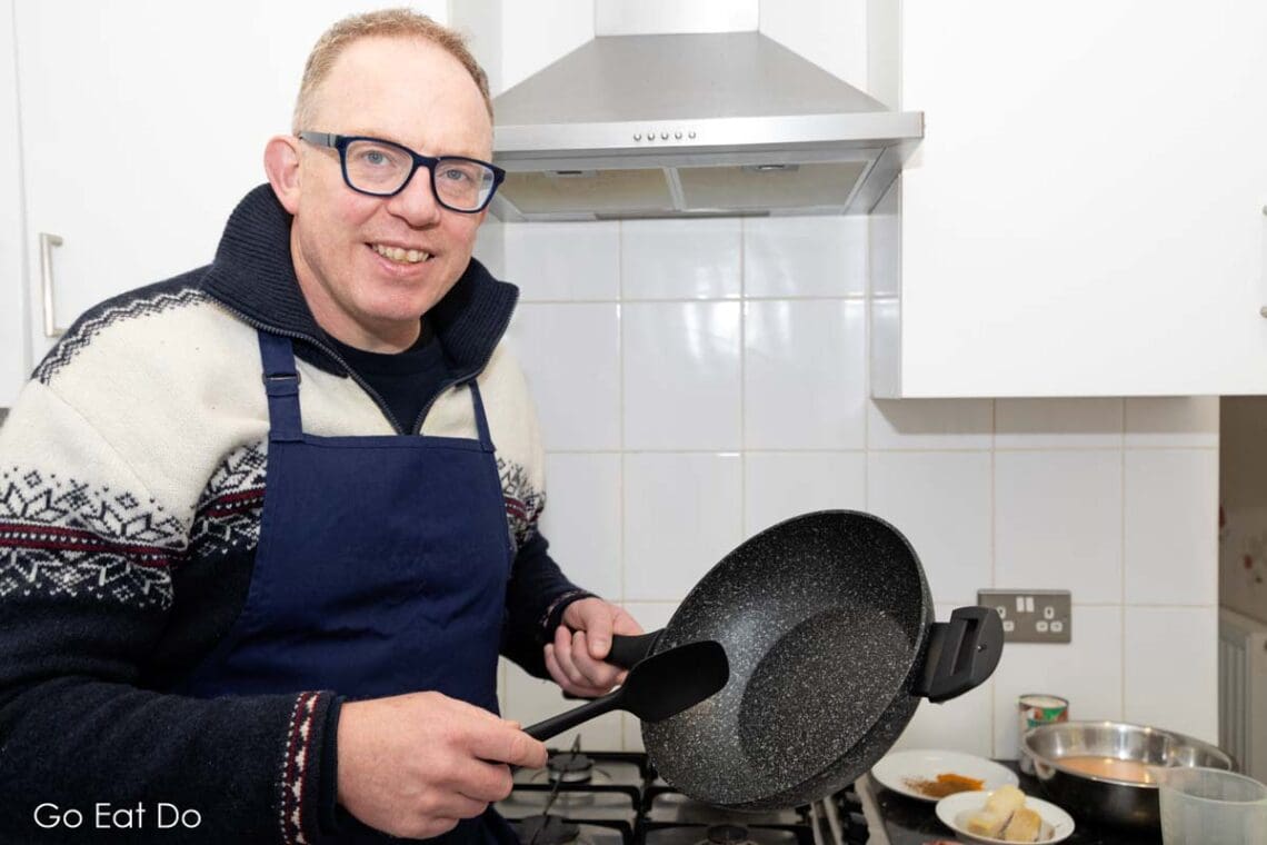 Stuart Forster cooking coconut dal with a 28cm Salter Megastone Wok ...